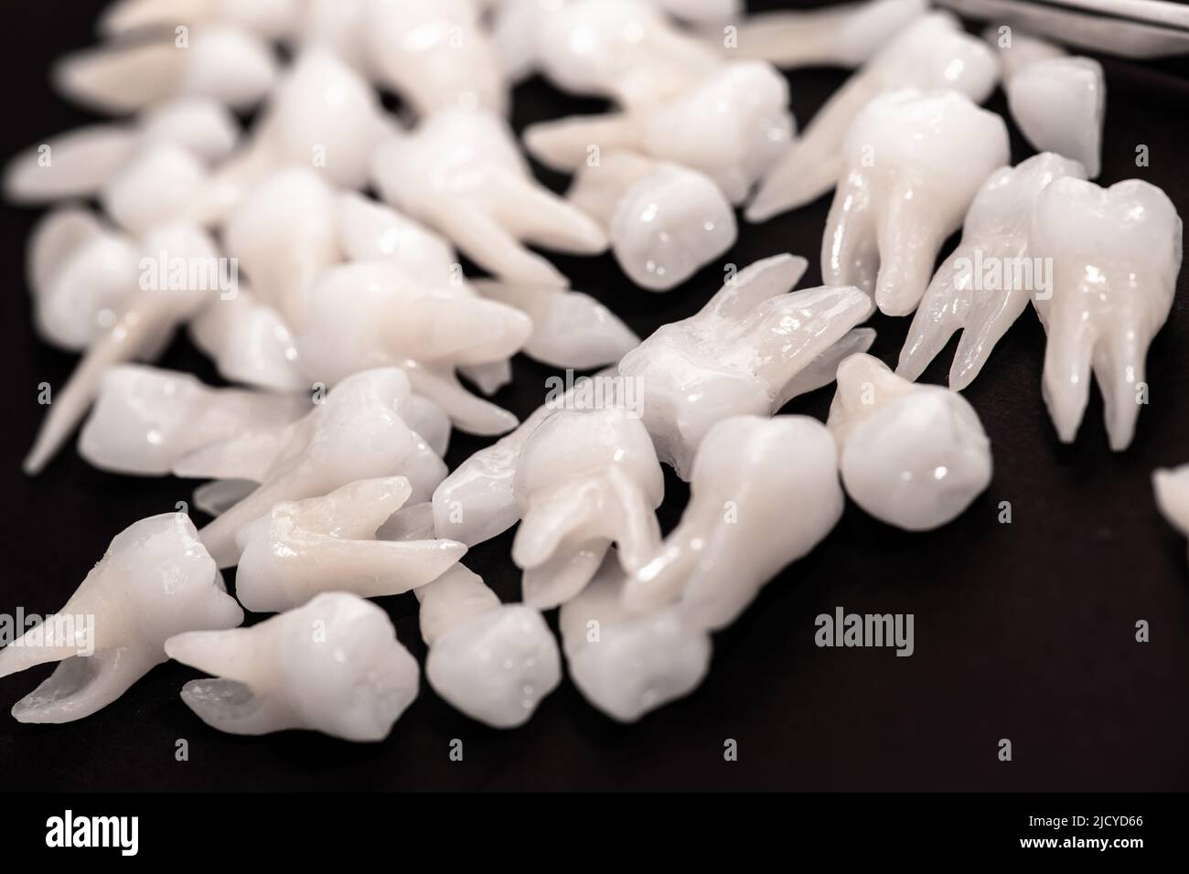 Teeth implant and crown installation process parts isolated on a blue ...