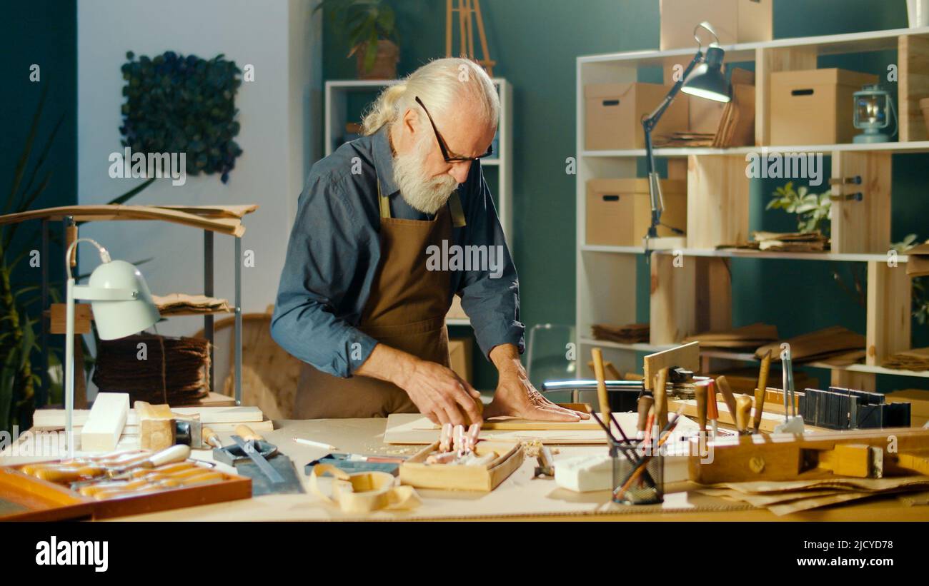 Professional Elderly Man Carpenter Working on Wood Using Carpentry ...