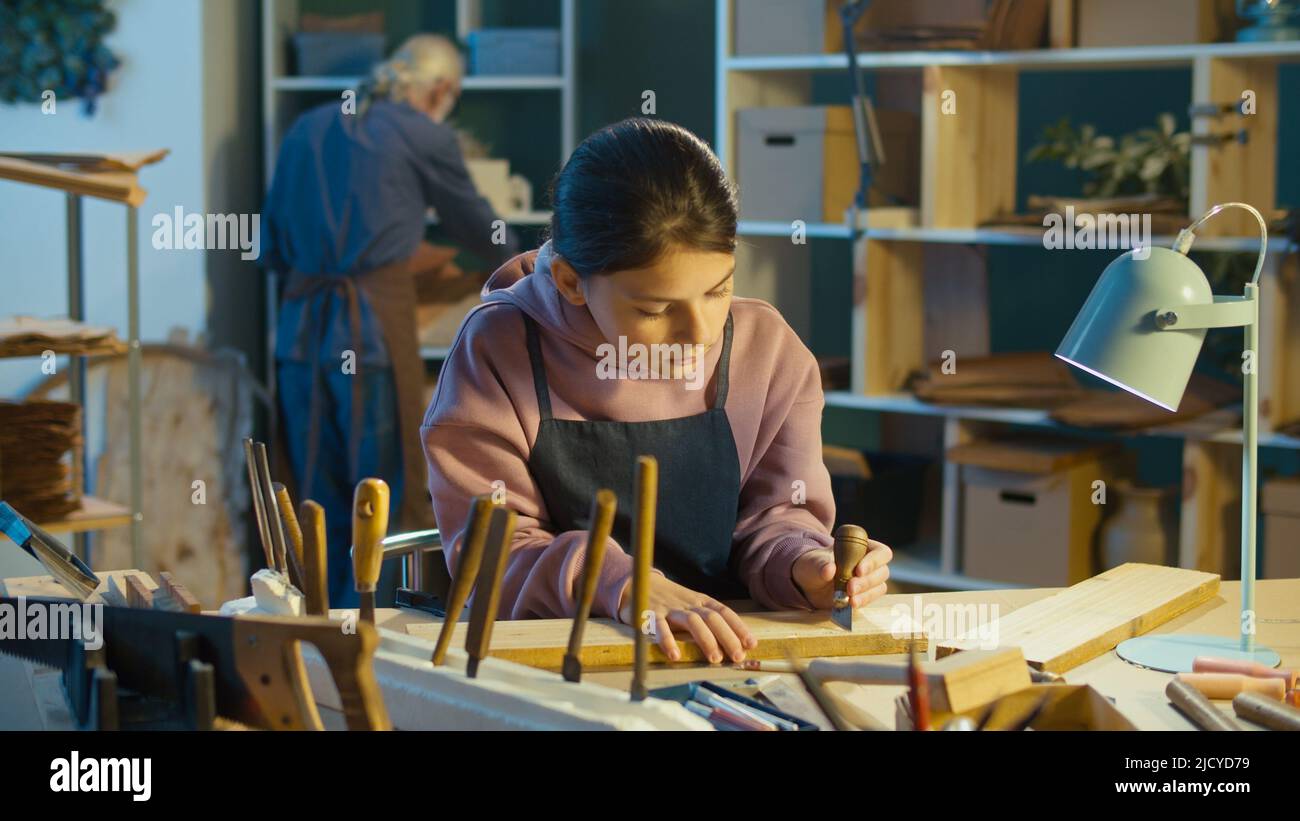 Teen Girl with Carpenter Grandfather Doing Woodcarving with Carpentry ...