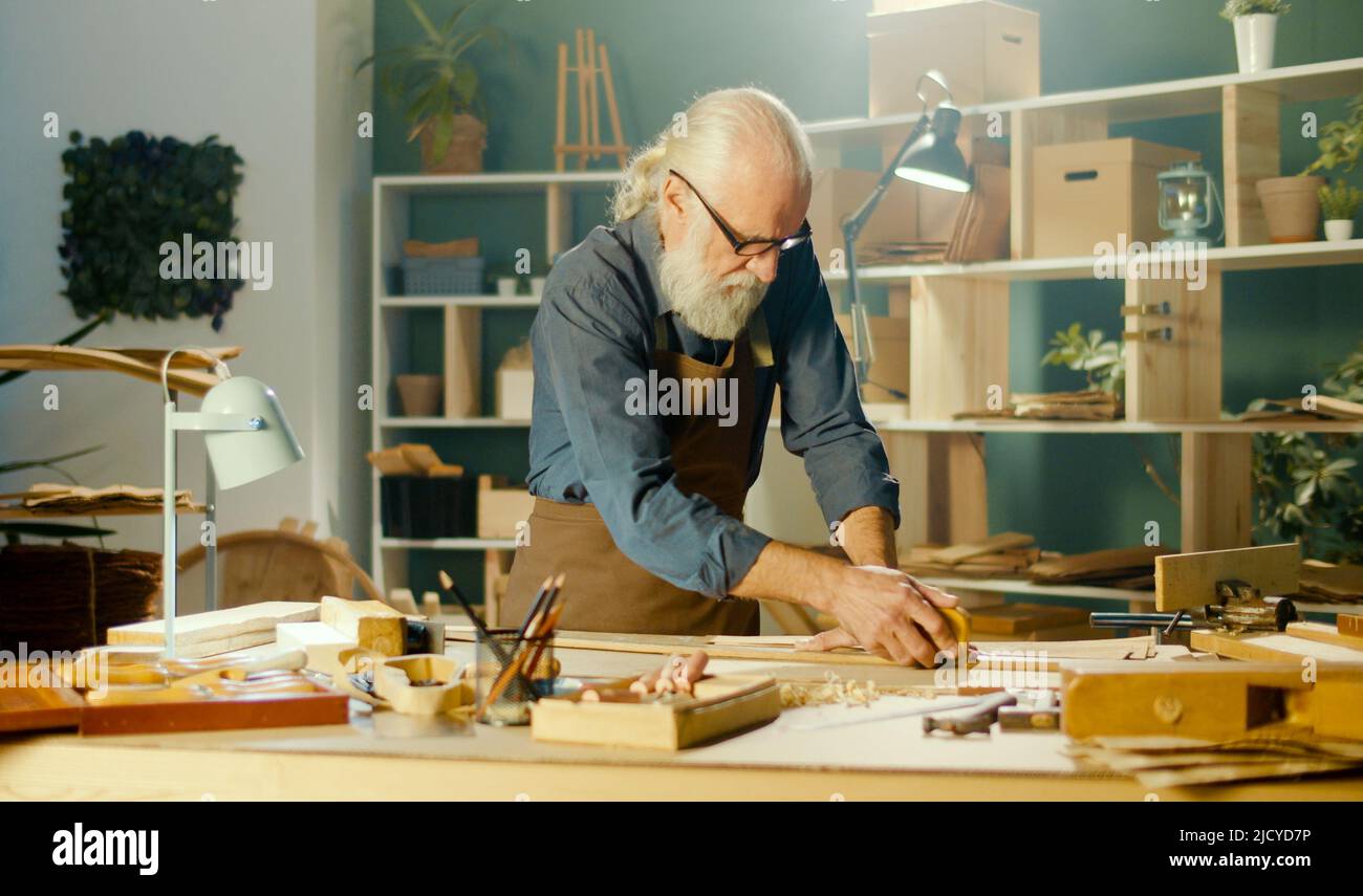 Professional Elderly Man Carpenter Working on Wood Using Carpentry ...