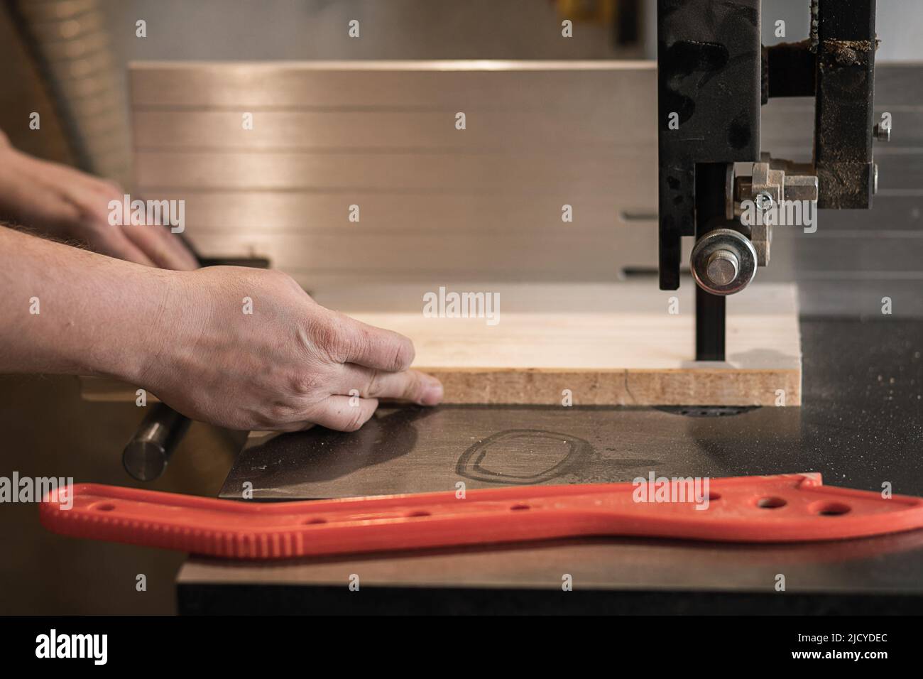Close-up cropped hands of carpenter professional man hands using panel ...
