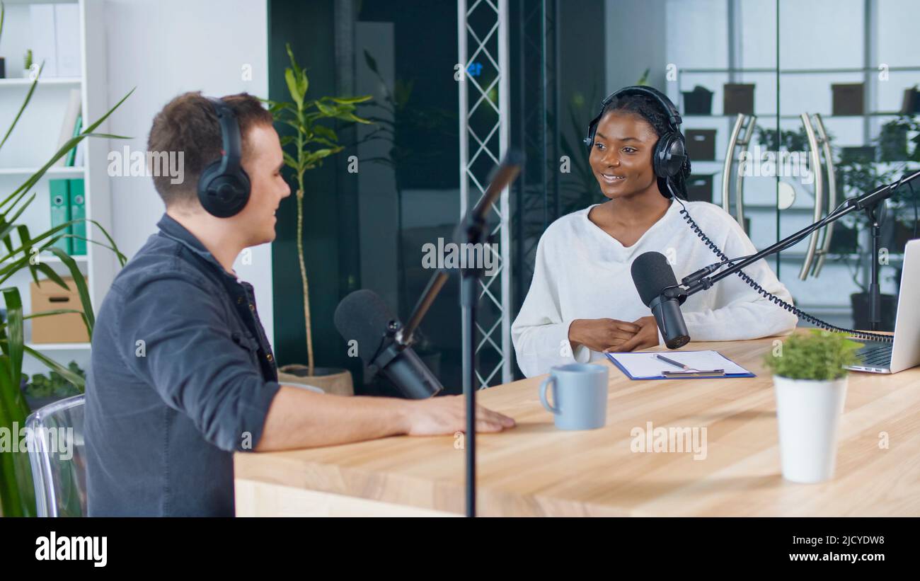 Female Host Talking to a Guest Friend on a Podcast Radio Station in the ...