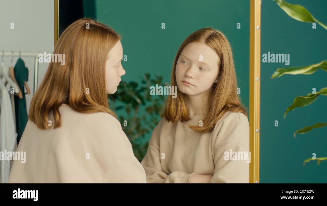 Depressed Red haired Teenage Girl Looking at Her Reflection in the ...