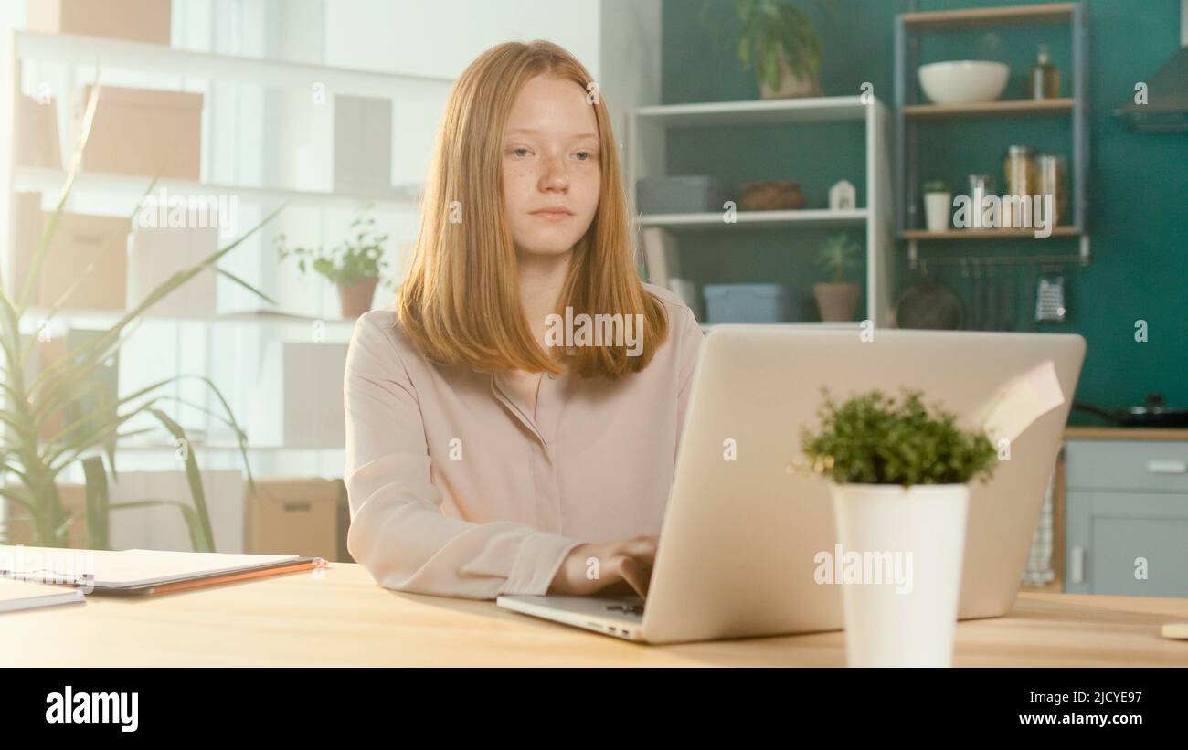 Tired Teenage Schoolgirl While Studying Online at a Laptop. Overwhelmed ...