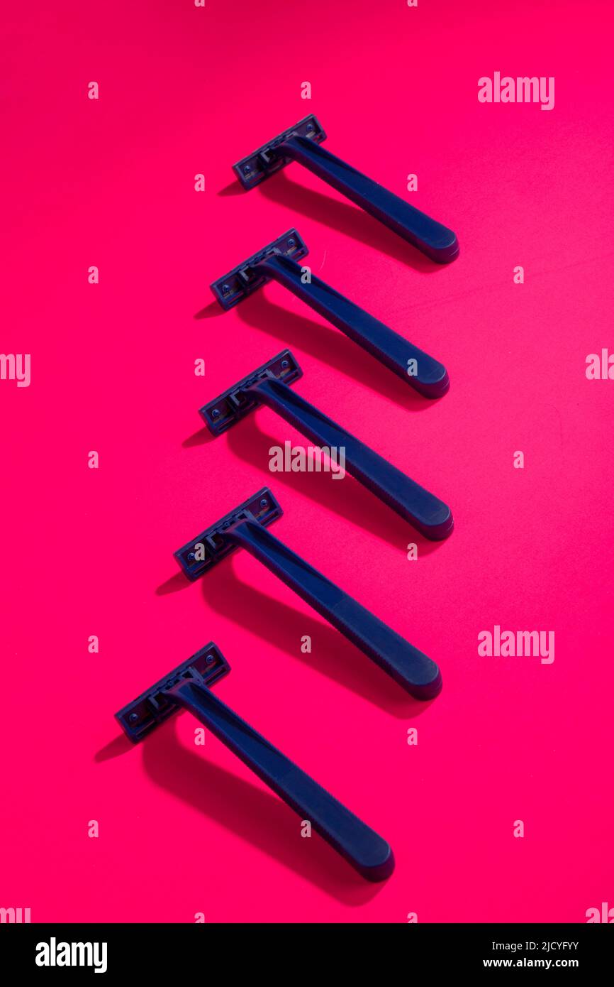 Abstract still life with razors on a colored background Stock Photo - Alamy