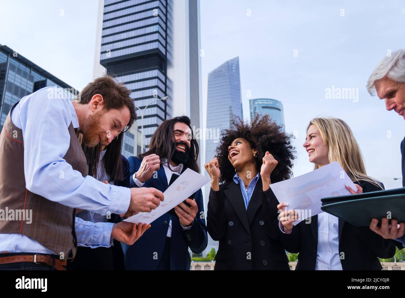 Diverse group of company workers celebrating successes together Stock ...