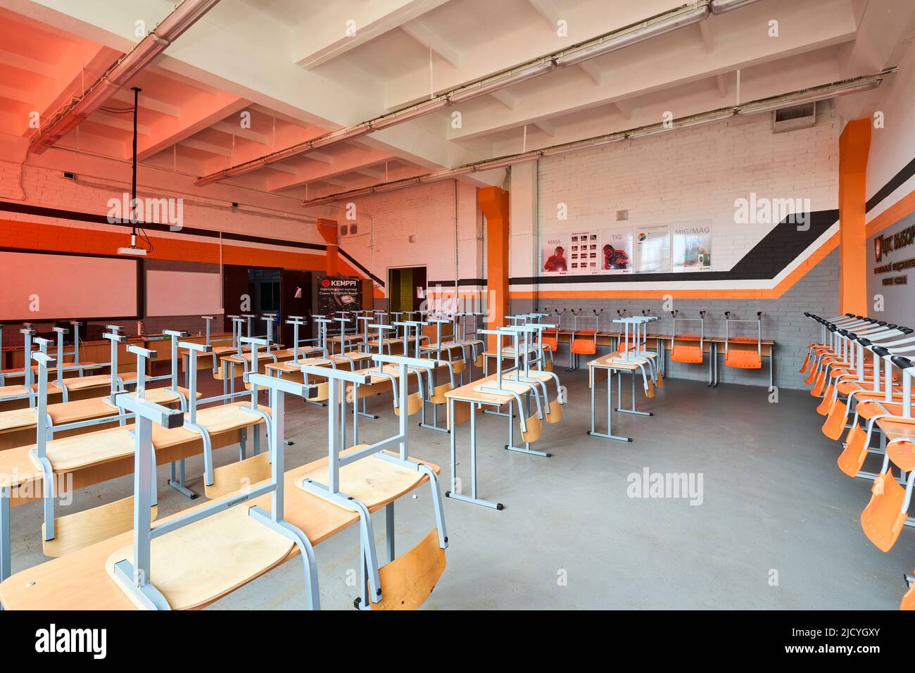 Empty classroom for classes in orange shades Stock Photo - Alamy
