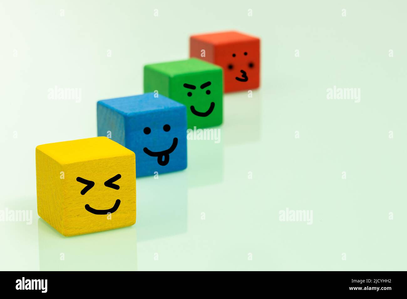 Colorful wooden blocks with emoticons Positive emotions, smiles, facial ...