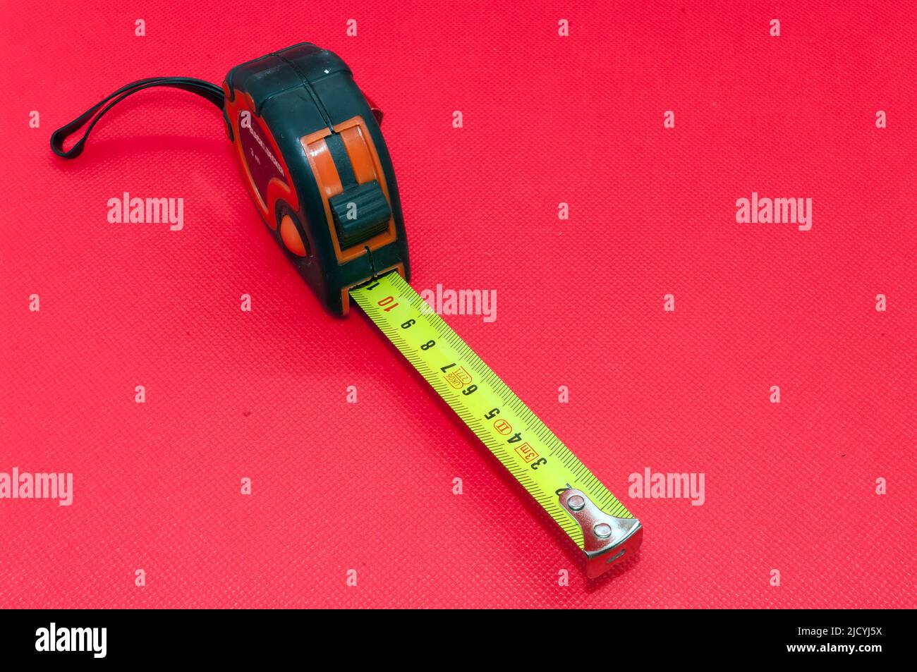 Symbol picture measure: roll up metal tape measure, cut out on red ...