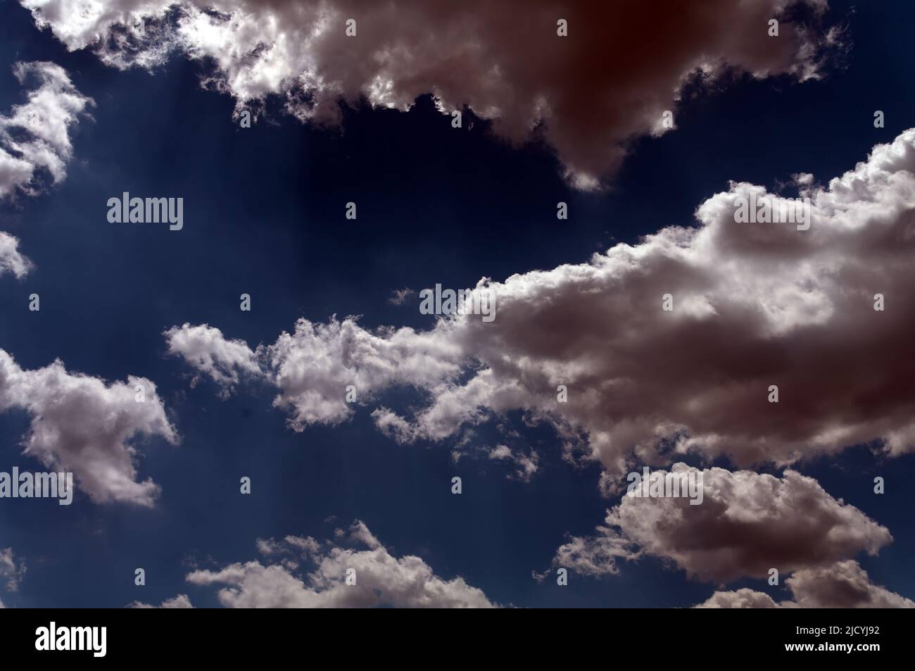 Gray and white dramatic cloud formation against steel blue sky Stock ...