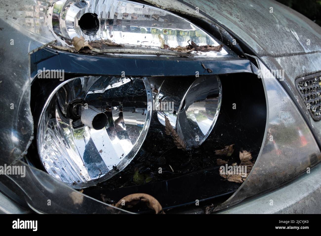 abandoned green car broken head lamp and indicator light with mould ...