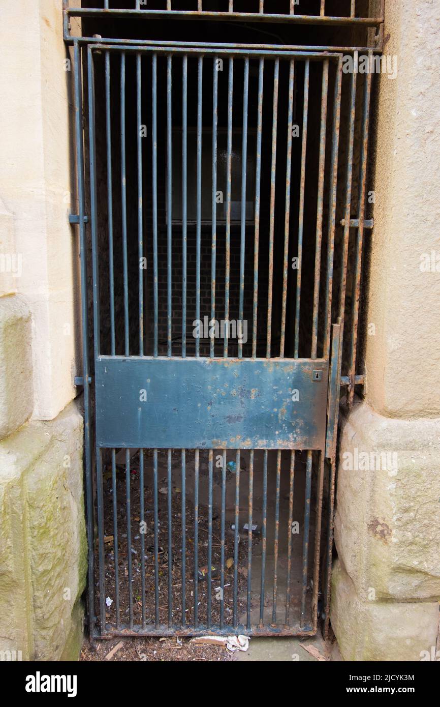 blue painted iron gate with a traditional stone wall Stock Photo - Alamy