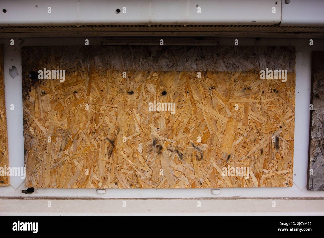 new piece of plywood boarding up a window Stock Photo - Alamy