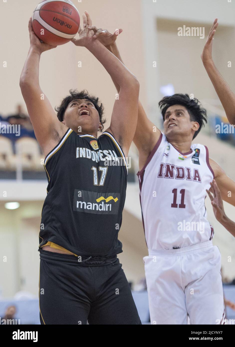 Zihad Visabililah (L) of Indonesia Basketball team and Janmejay Singh (R) of India Basketball ...