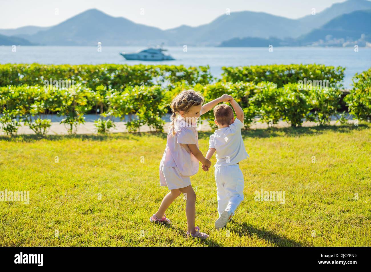 Portrait of two cute adorable baby children toddlers hugging and ...