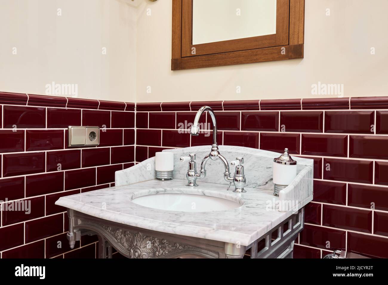 Horizontal photo of bathroom faucet with red tile Stock Photo - Alamy