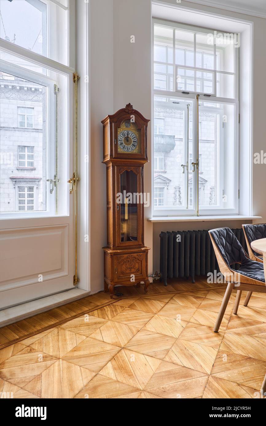 Vintage clock with a pendulum in the apartment Stock Photo - Alamy