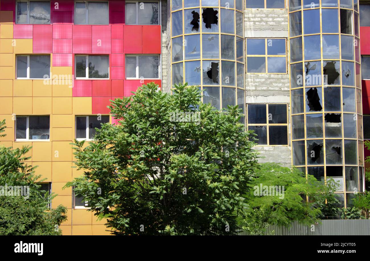 Shattered glass of an office building. Modern commercial building with ...