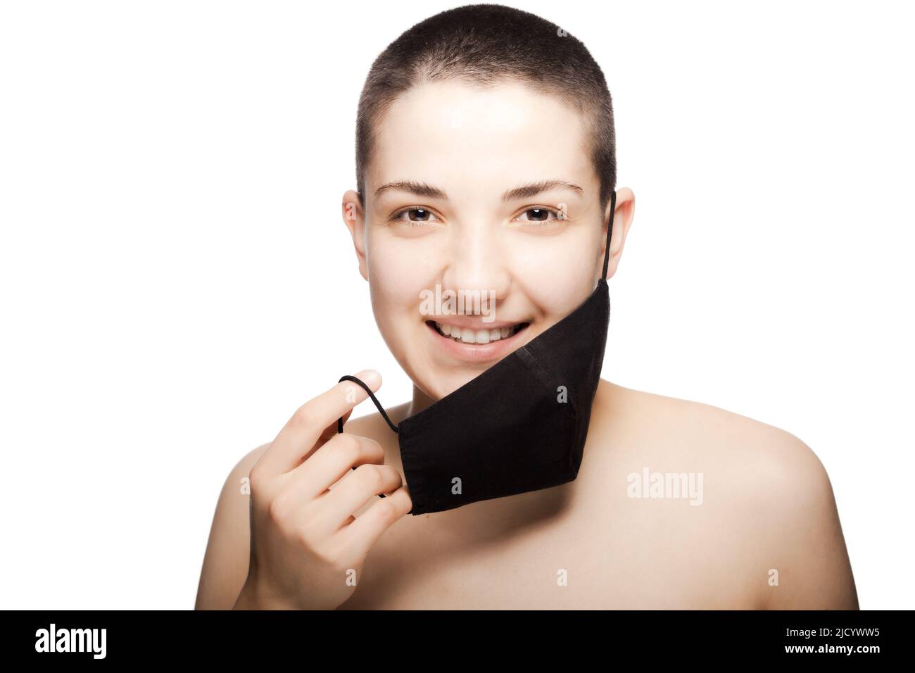 Cute girl with very short hair wearing black protective face mask ...