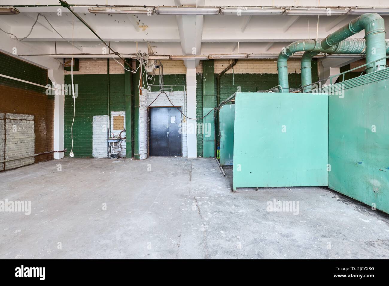 Old abandoned brick building with green walls Stock Photo - Alamy