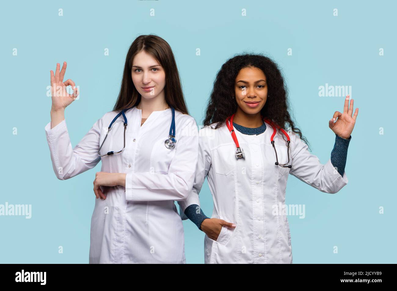 Friendly Two Female Doctors GP Shows Approval Gesture, OK sign, Like on ...