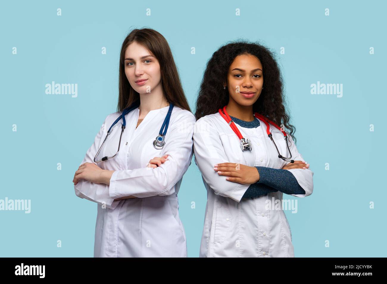 Portrait Two Half-turned Friendly Female Doctors GP with Arms Crossed ...
