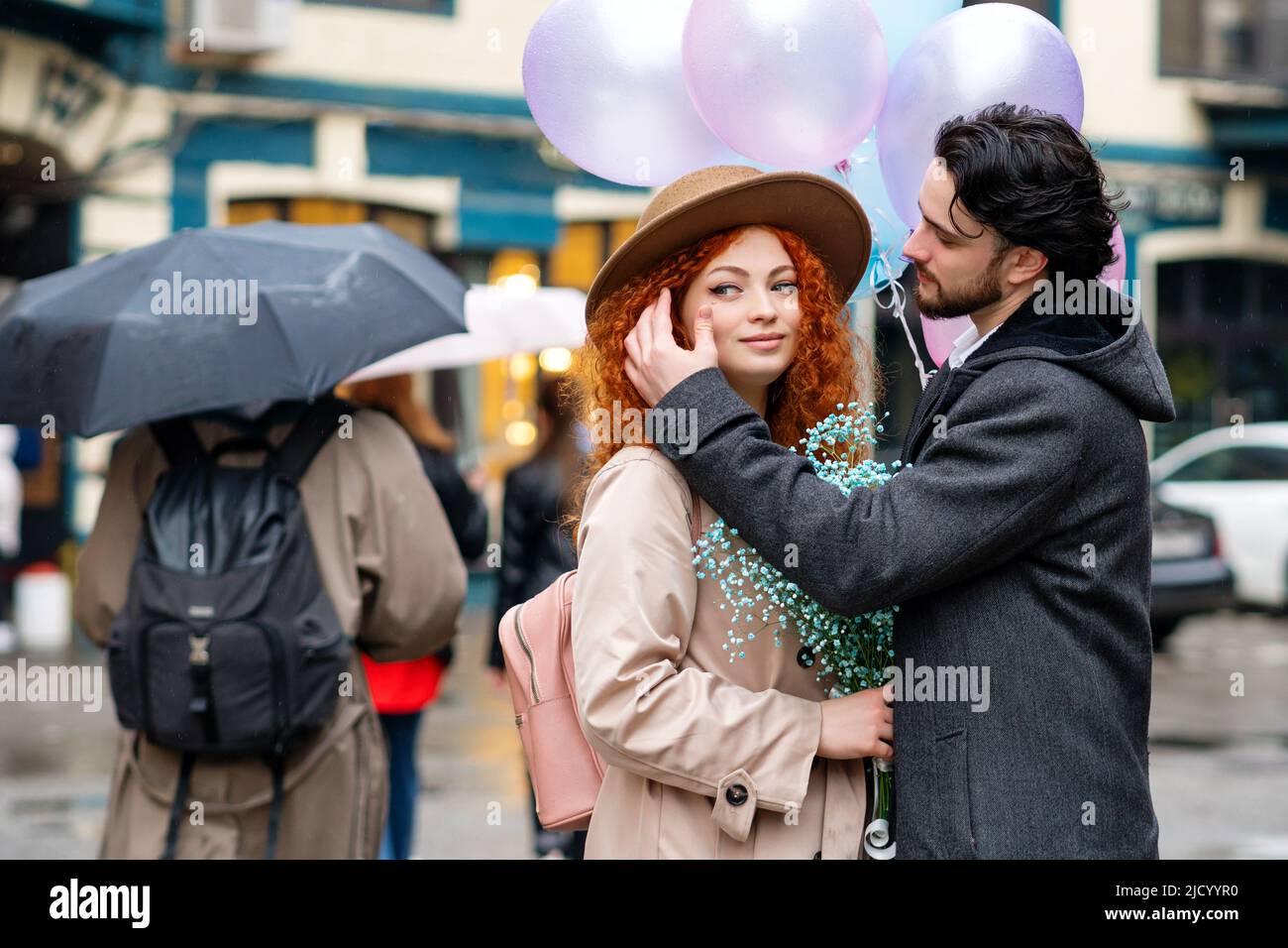 Caring boyfriend fixing his girlfriend hairdo. Heterosexual Couple on ...
