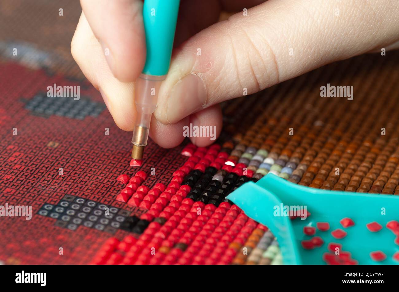 Collecting diamond embroidery, diamond mosaic. Colored crystals Stock ...