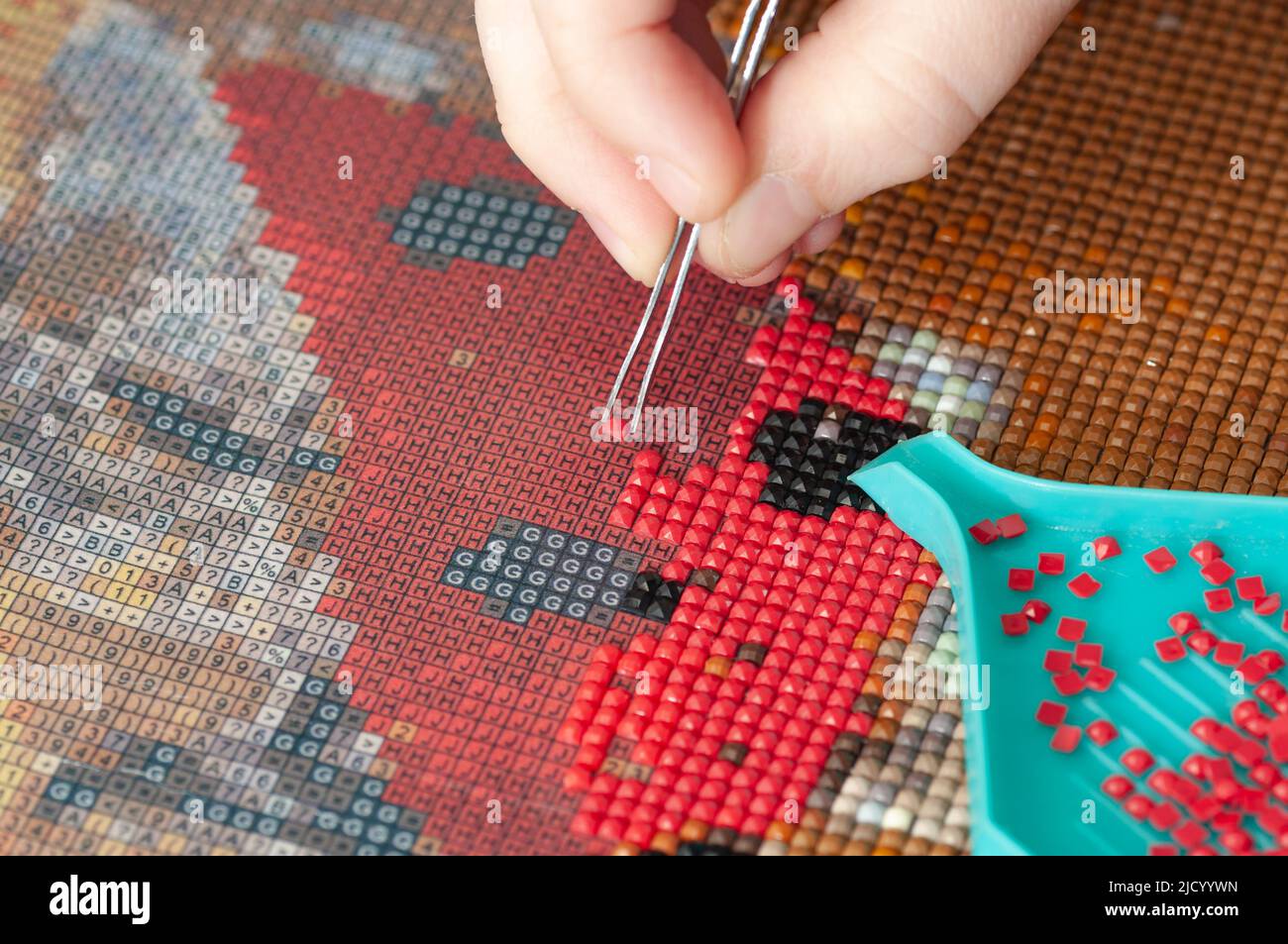 Collecting diamond embroidery, diamond mosaic. Colored crystals Stock ...