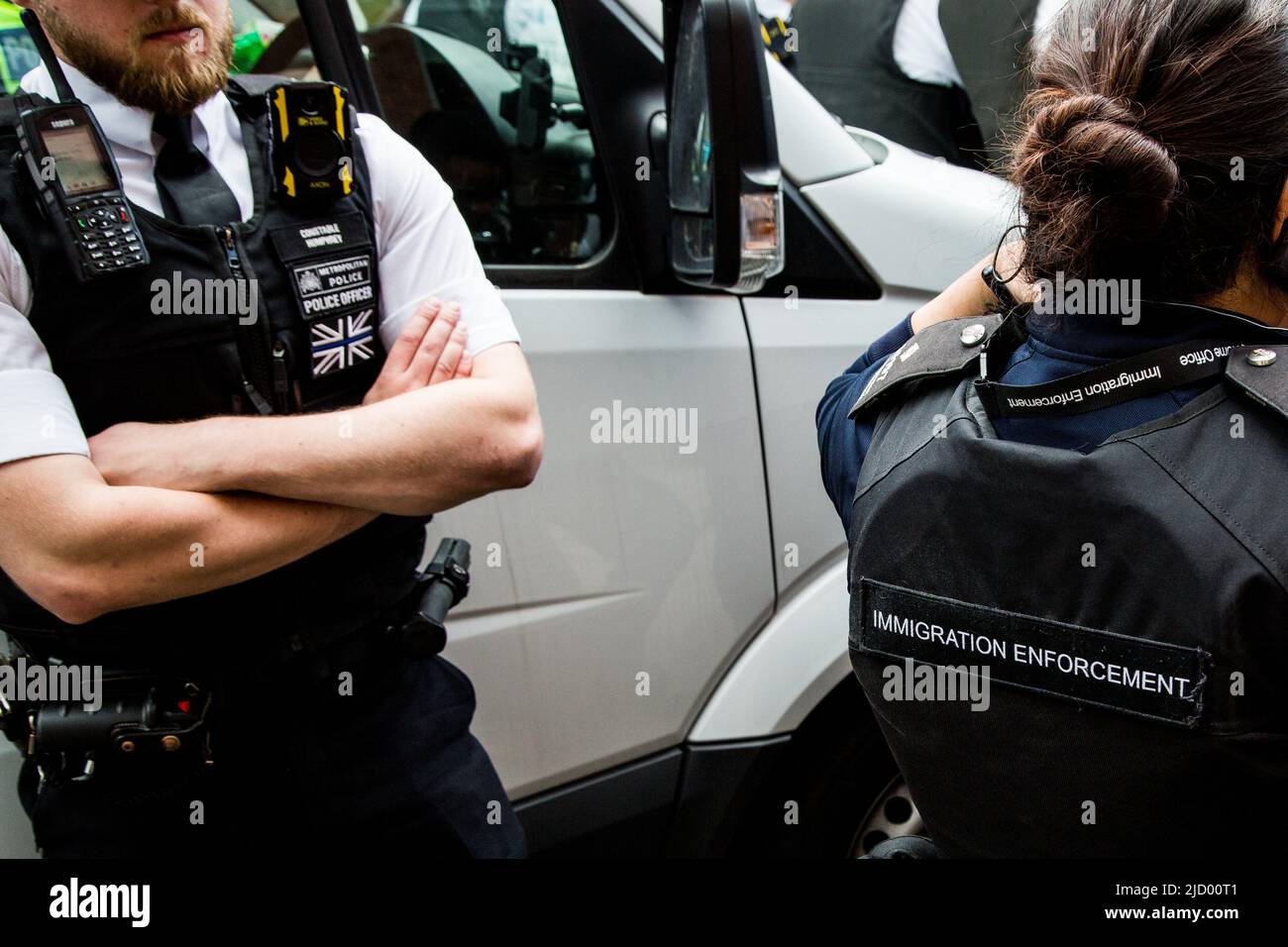 11 June 2022 Police and immigration officers stand alert during an ...