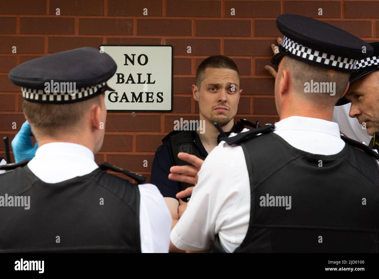 11 June 2022 Police talk to a immigration officer (C) during an ...