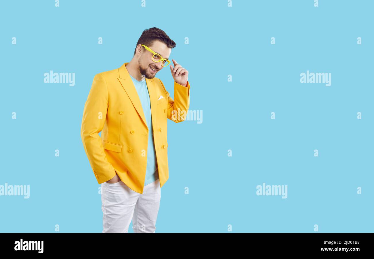 Portrait of cheerful cool and stylish millennial man in colorful outfit ...