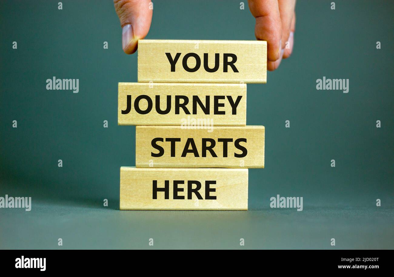 Your journey starts here symbol. Concept words Your journey starts here on wooden blocks on a ...