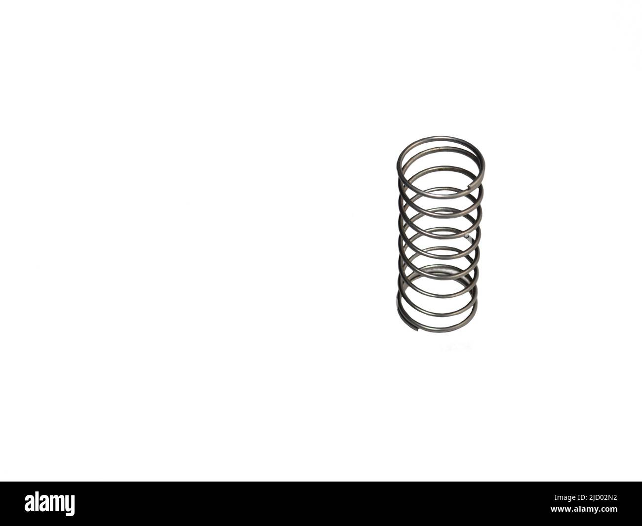 Metal spring on a white background. Mechanism element Stock Photo - Alamy