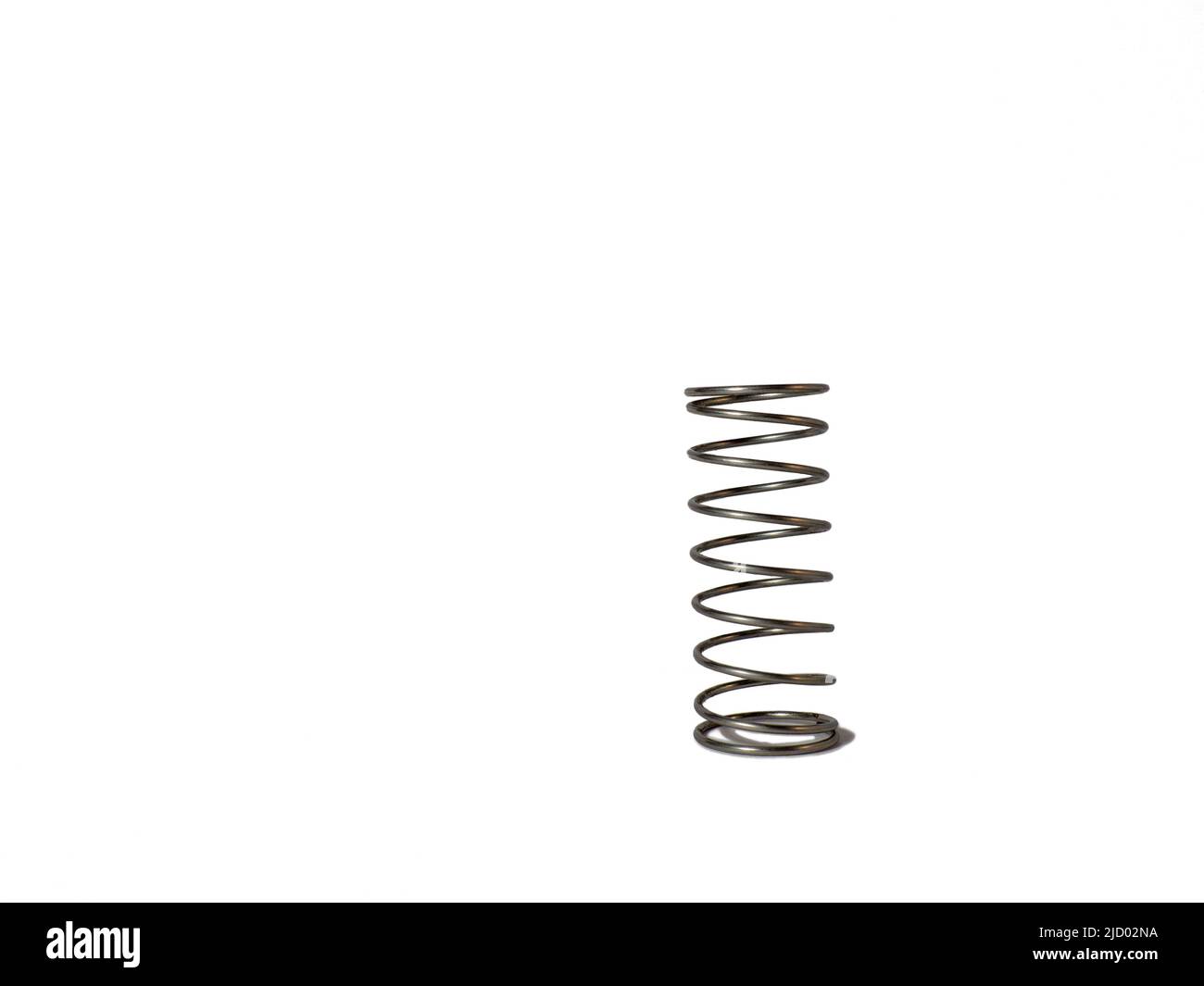 Metal spring on a white background. Mechanism element Stock Photo - Alamy