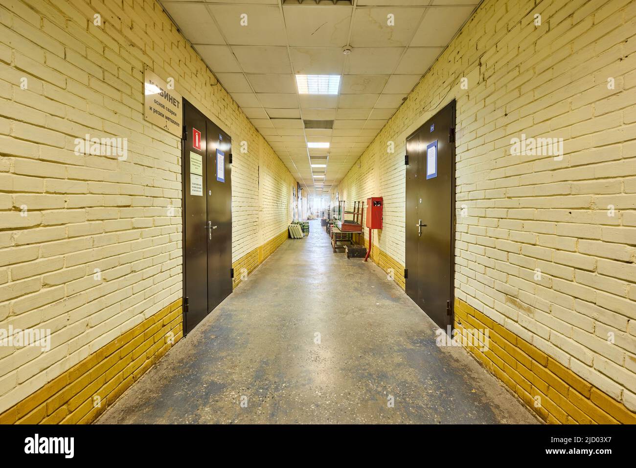 The long beige corridor with brick walls Stock Photo - Alamy
