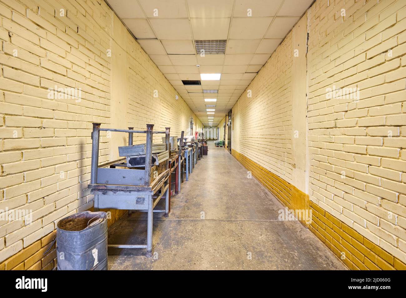 The long beige corridor with brick walls Stock Photo - Alamy
