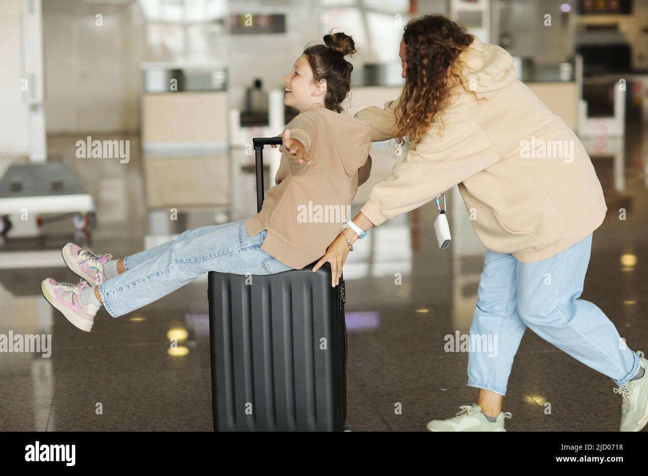 Summer Vacation Concept. Portrait of cheerful positive teen girl having fun and spreading hands ...