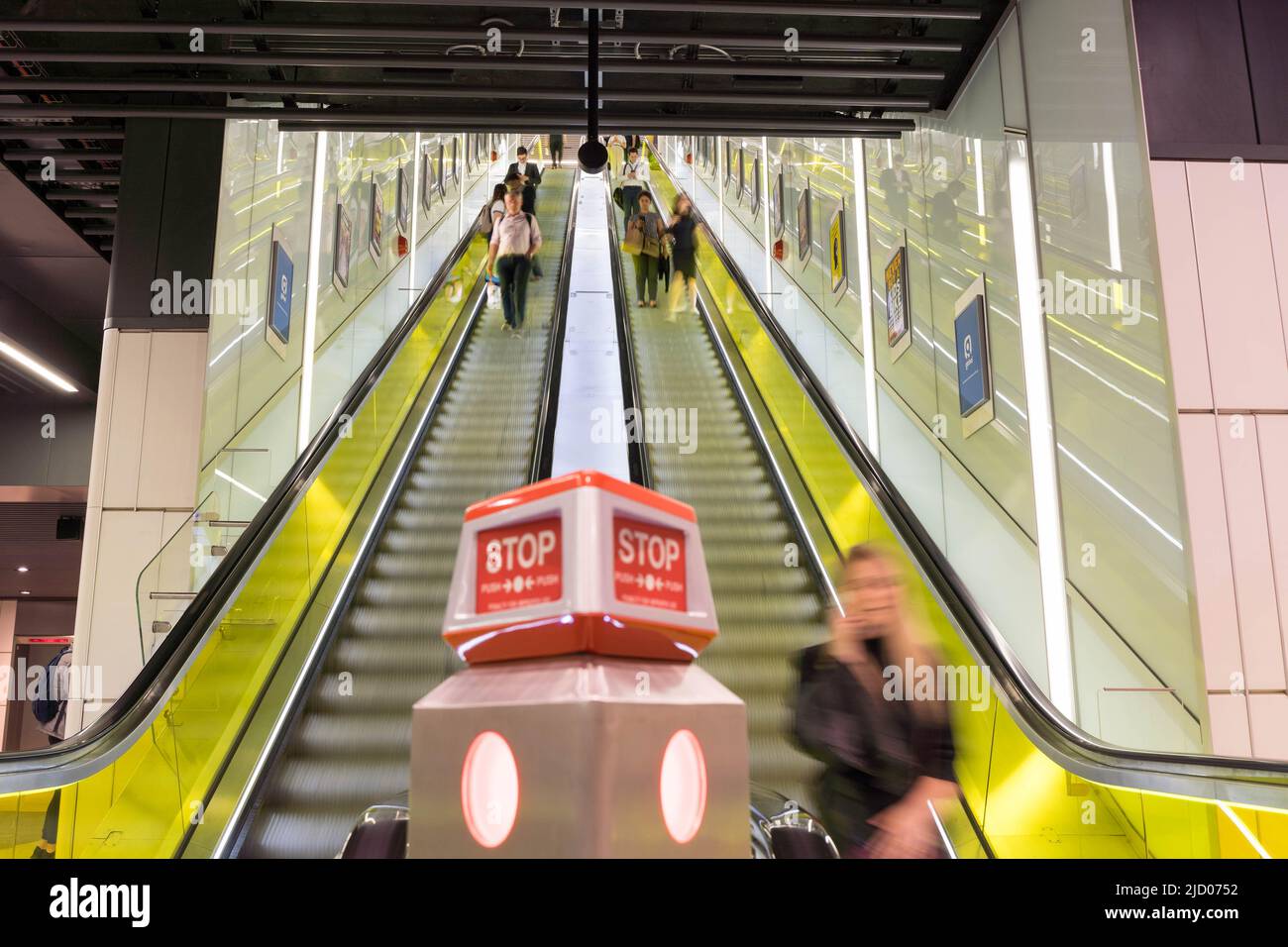 Escalators illuminated in yellow at Elizabeth line station London ...