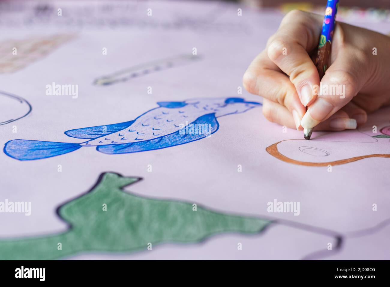 detailed view of the hand of a young college girl, painting with her ...