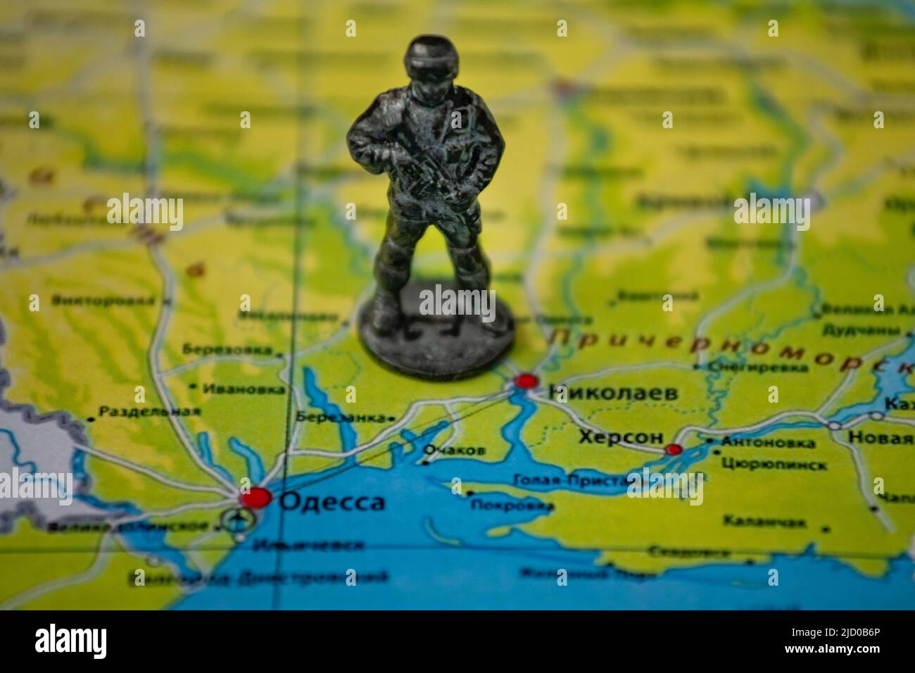 Metal figurine of a soldier on the background of the map of Ukraine ...