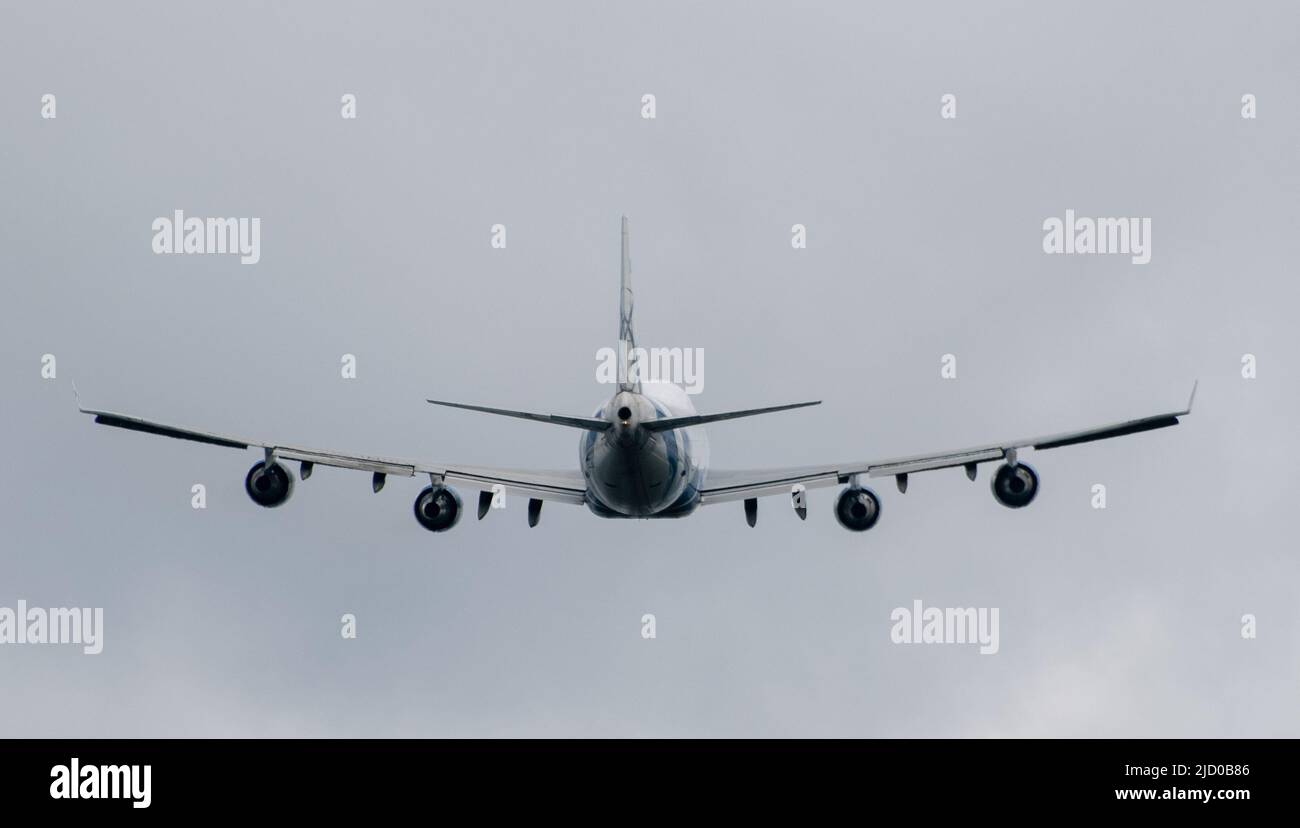 Passenger plane comes in for landing in cloudy weather Stock Photo - Alamy