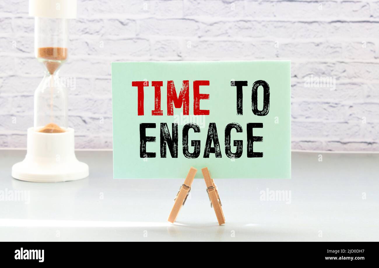 Text Time to engage on blackboard near alarm clock Stock Photo - Alamy