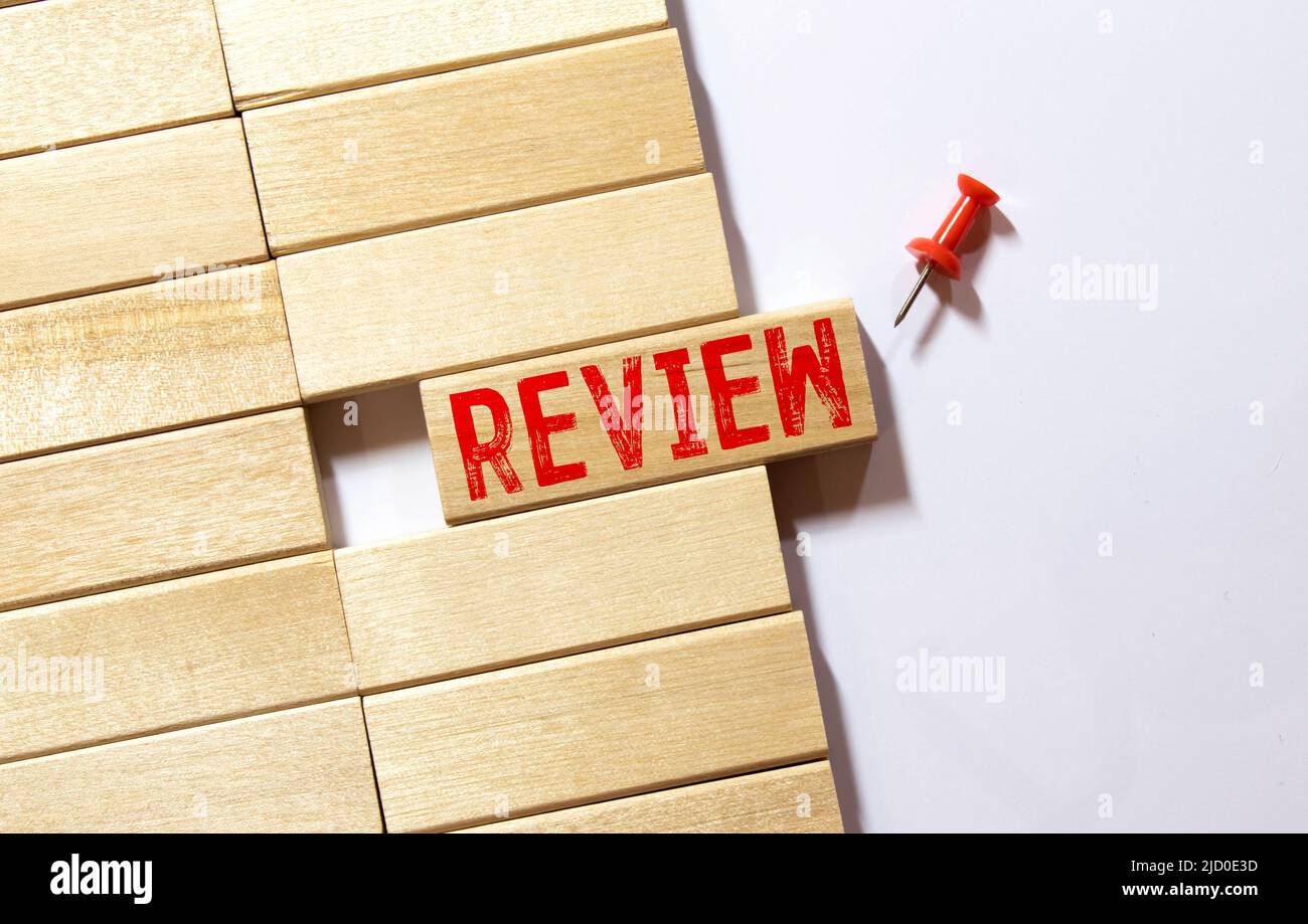 Review headline sign made of wood on a table Stock Photo - Alamy