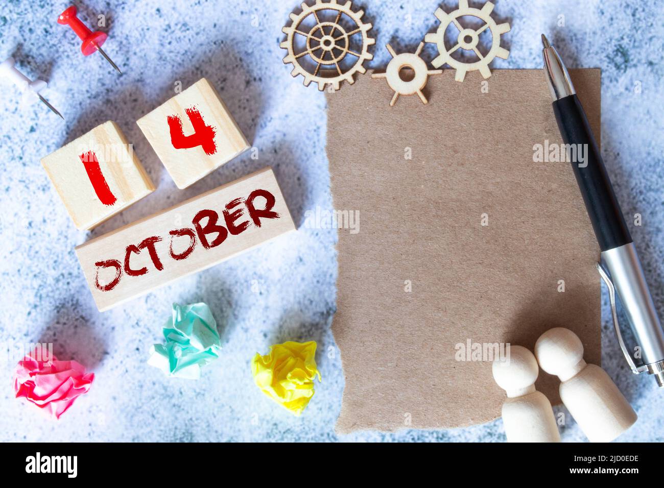 wooden calendar with the date of October 14 and an easel on a blue ...