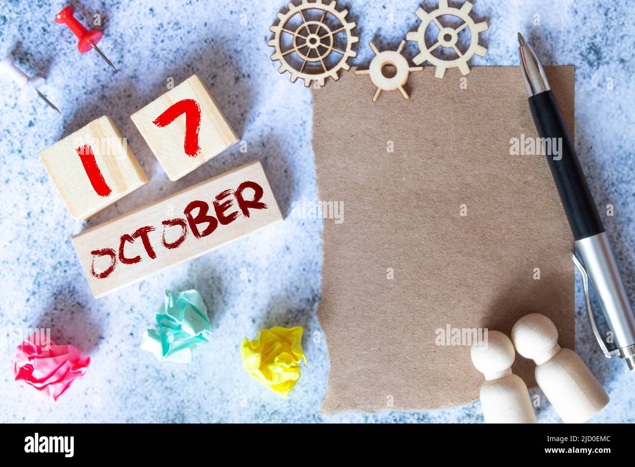 wooden calendar with the date of October 17 and an easel on a blue ...