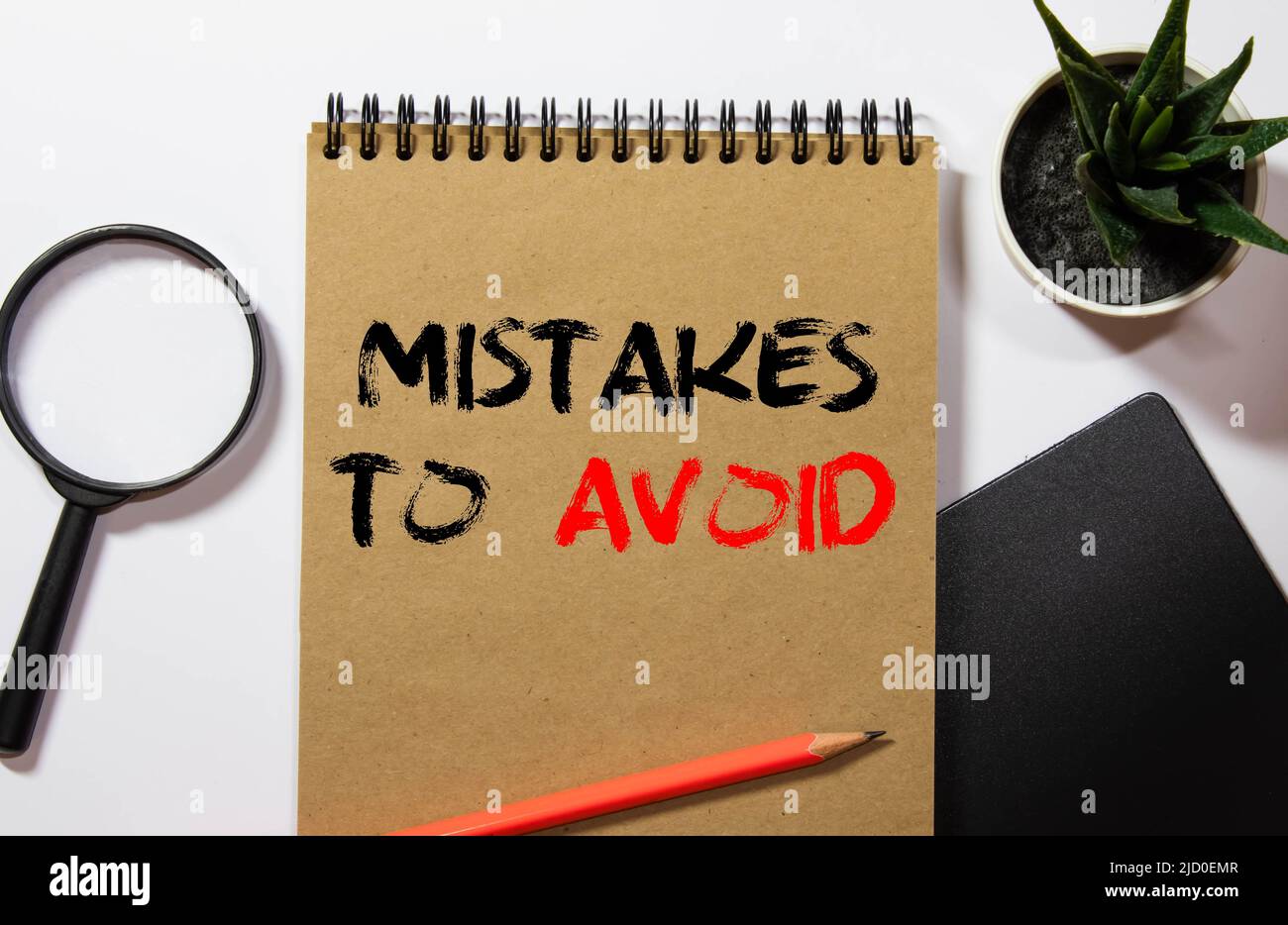 Notepad with text Mistakes To Avoid lying on financial tables with a ... Notepad with text Mistakes To Avoid lying on financial tables with a ...