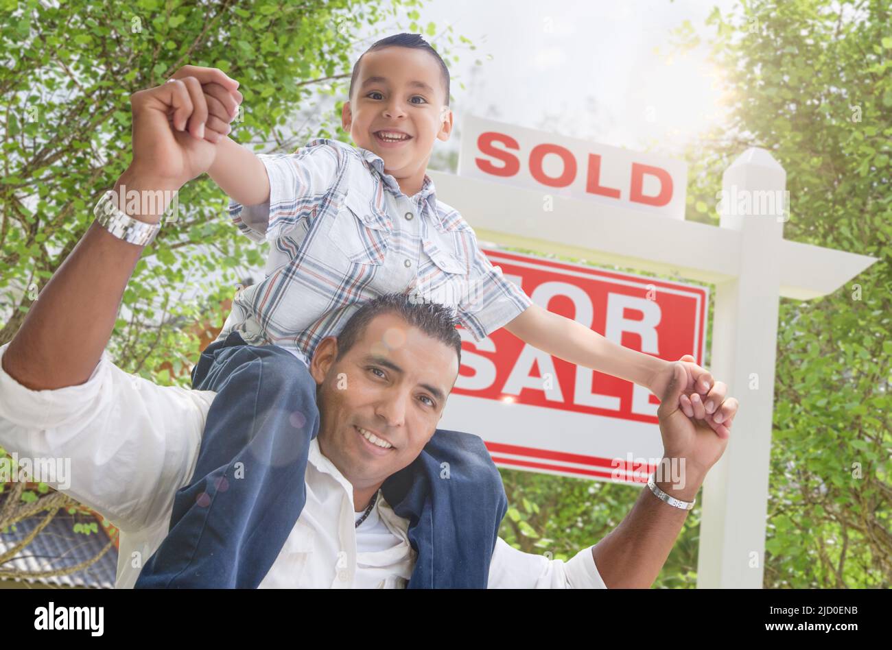 Happy Young Hispanic Father and Son In Front of Sold For Sale Real ...