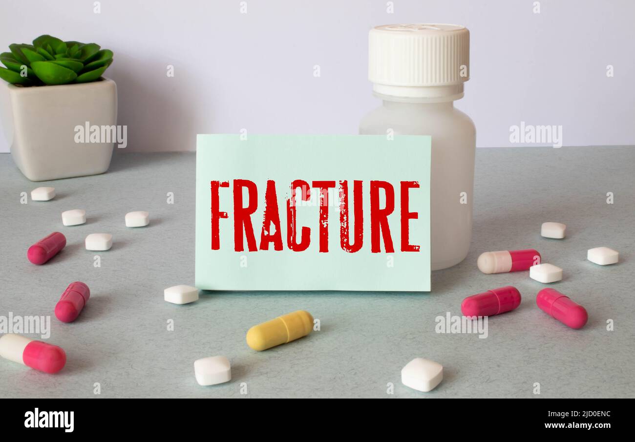 word fracture made from brown wooden letters lies on a gray background ...