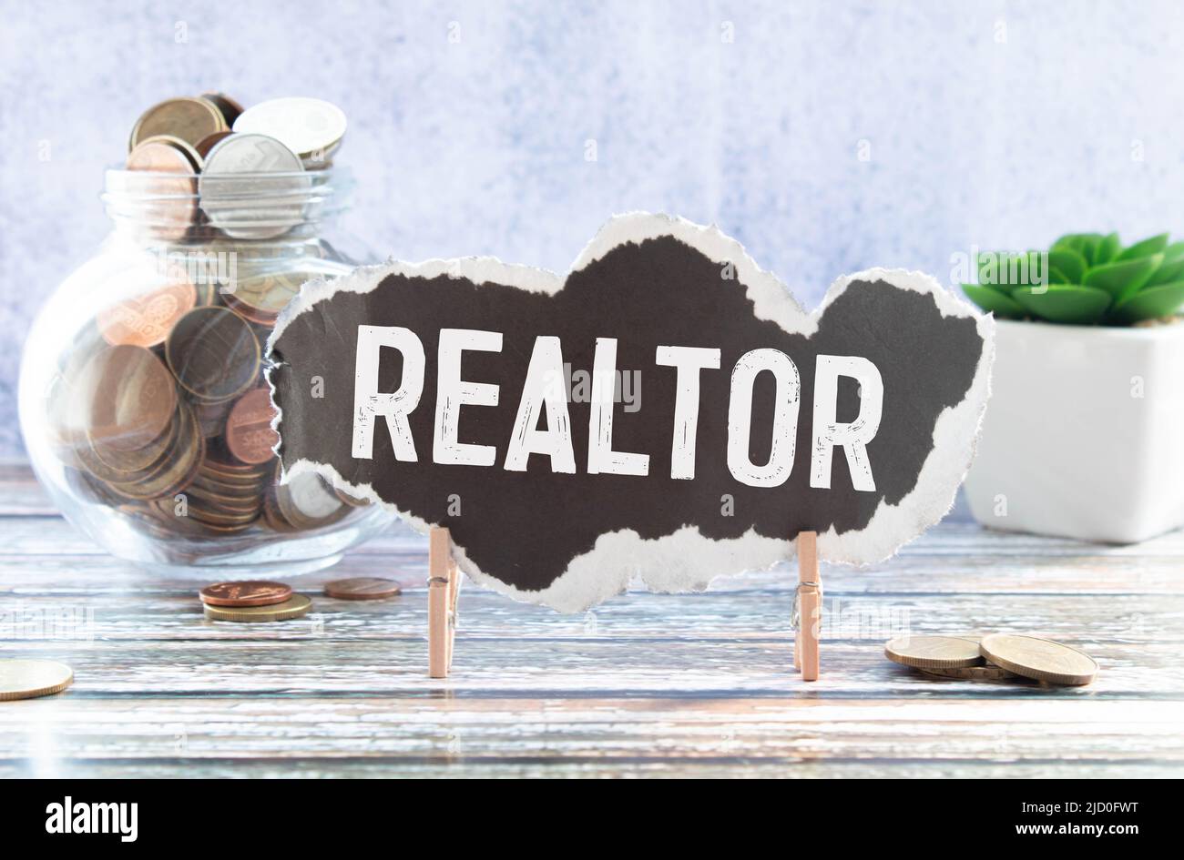 Cubes form the word realtor in front of a miniature house Stock Photo ...